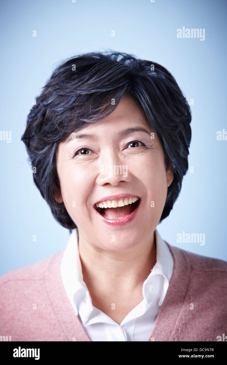 close up shot of a middle aged woman laughing Stock Photo - Alamy
