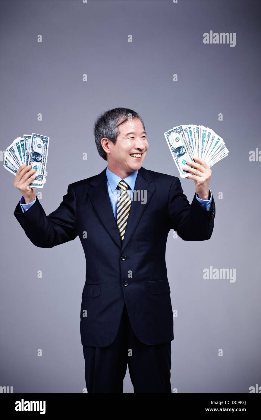 middle aged man in a business suit holding bunch of money Stock Photo ...