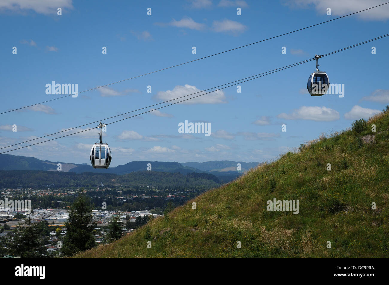 Two bubble lifts traveling uphill Stock Photo - Alamy
