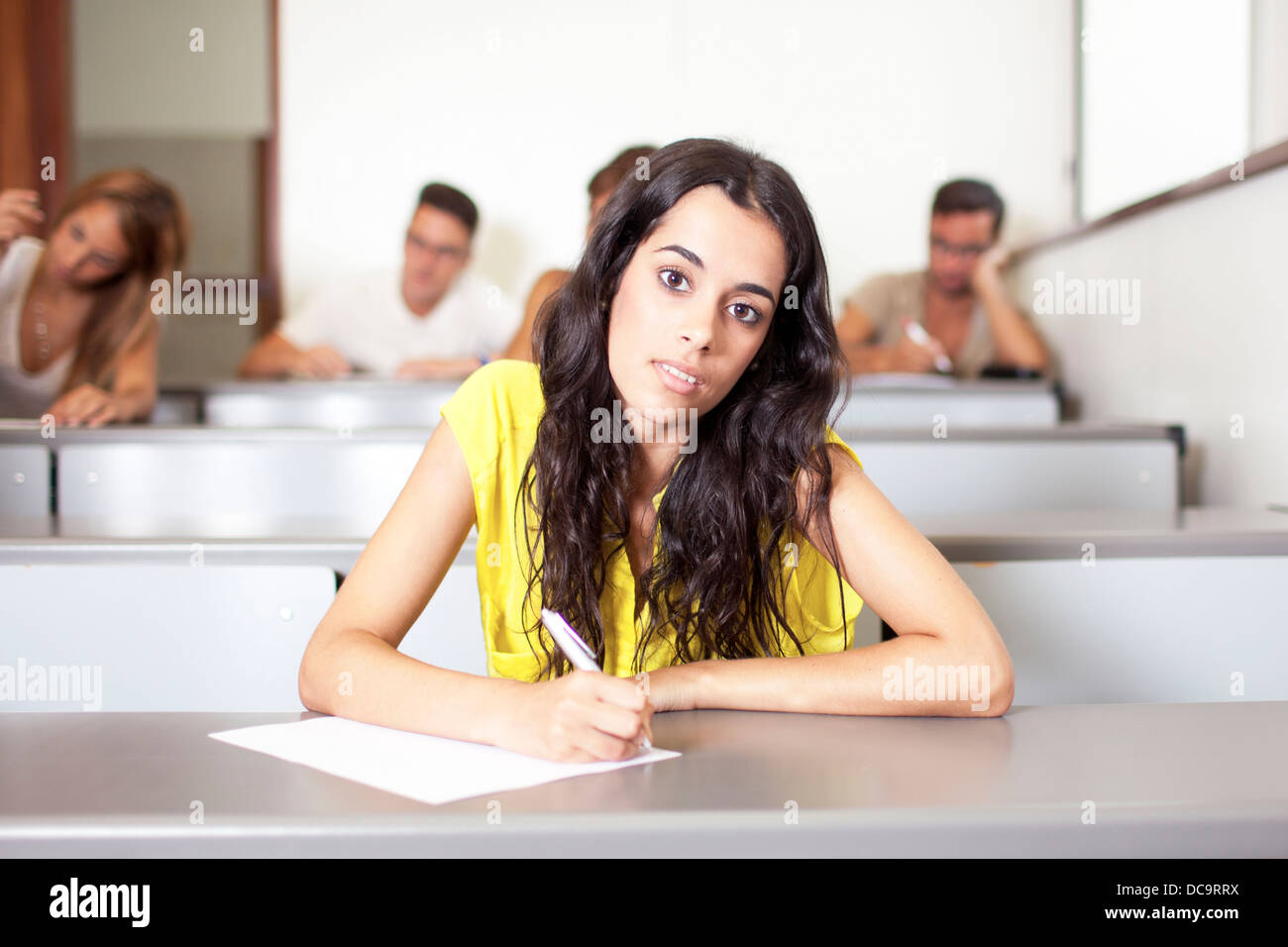 Beautiful young student writing an exam Stock Photo - Alamy
