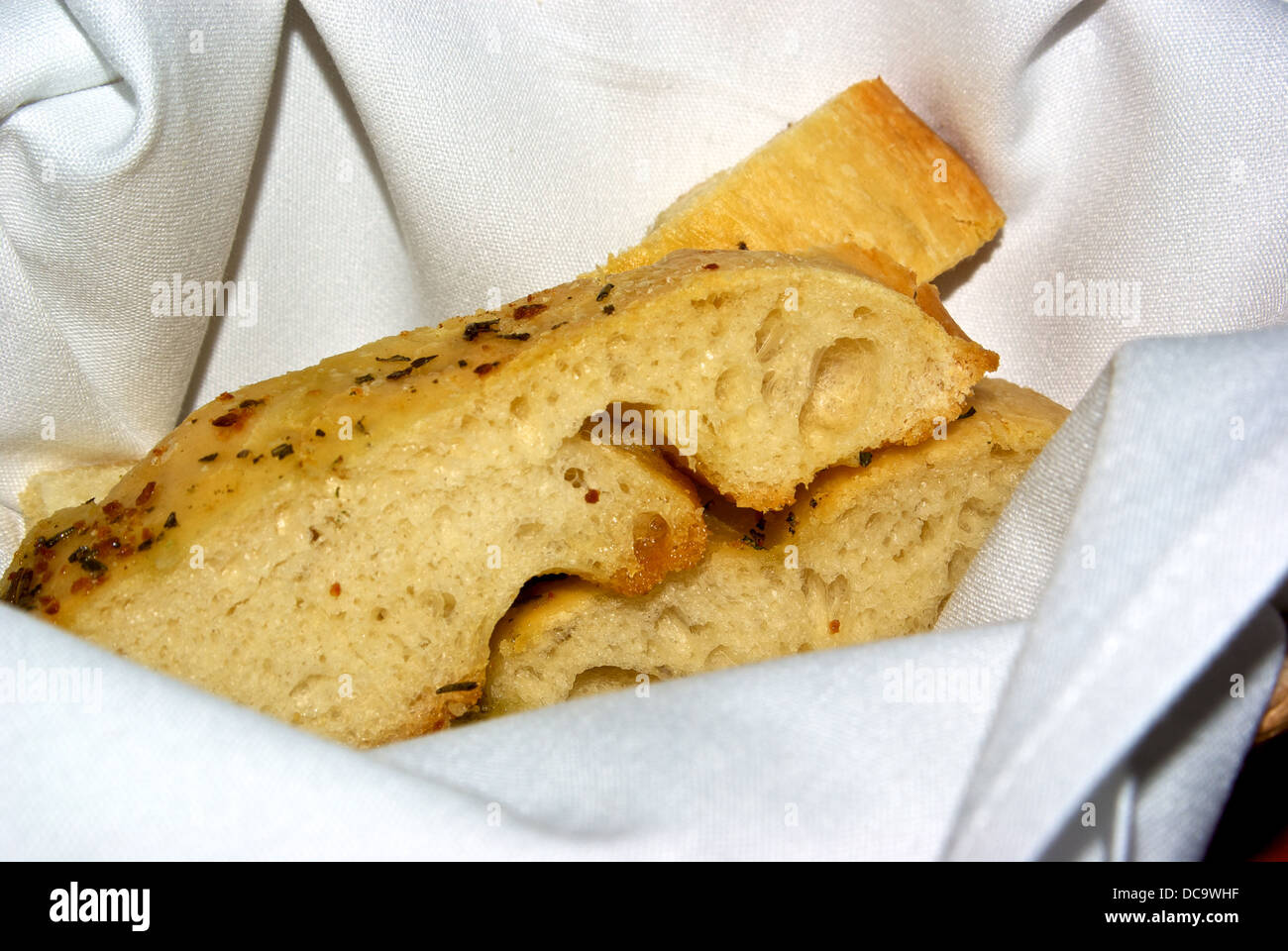 Slices baked herb focaccia bread napkin lined basket Stock Photo - Alamy