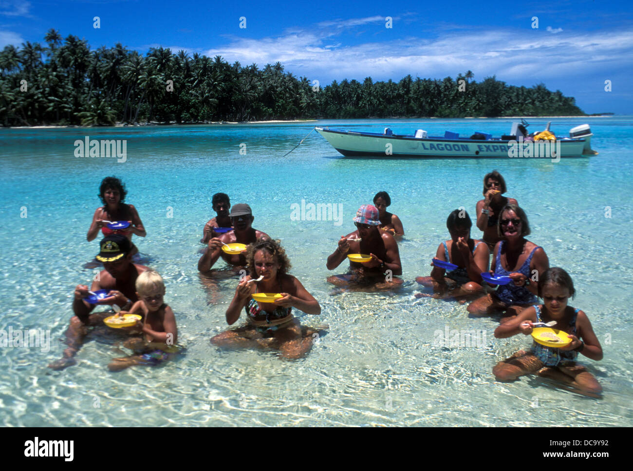 French tourists eating lunch in a lagoon on the island of Taha'a ...