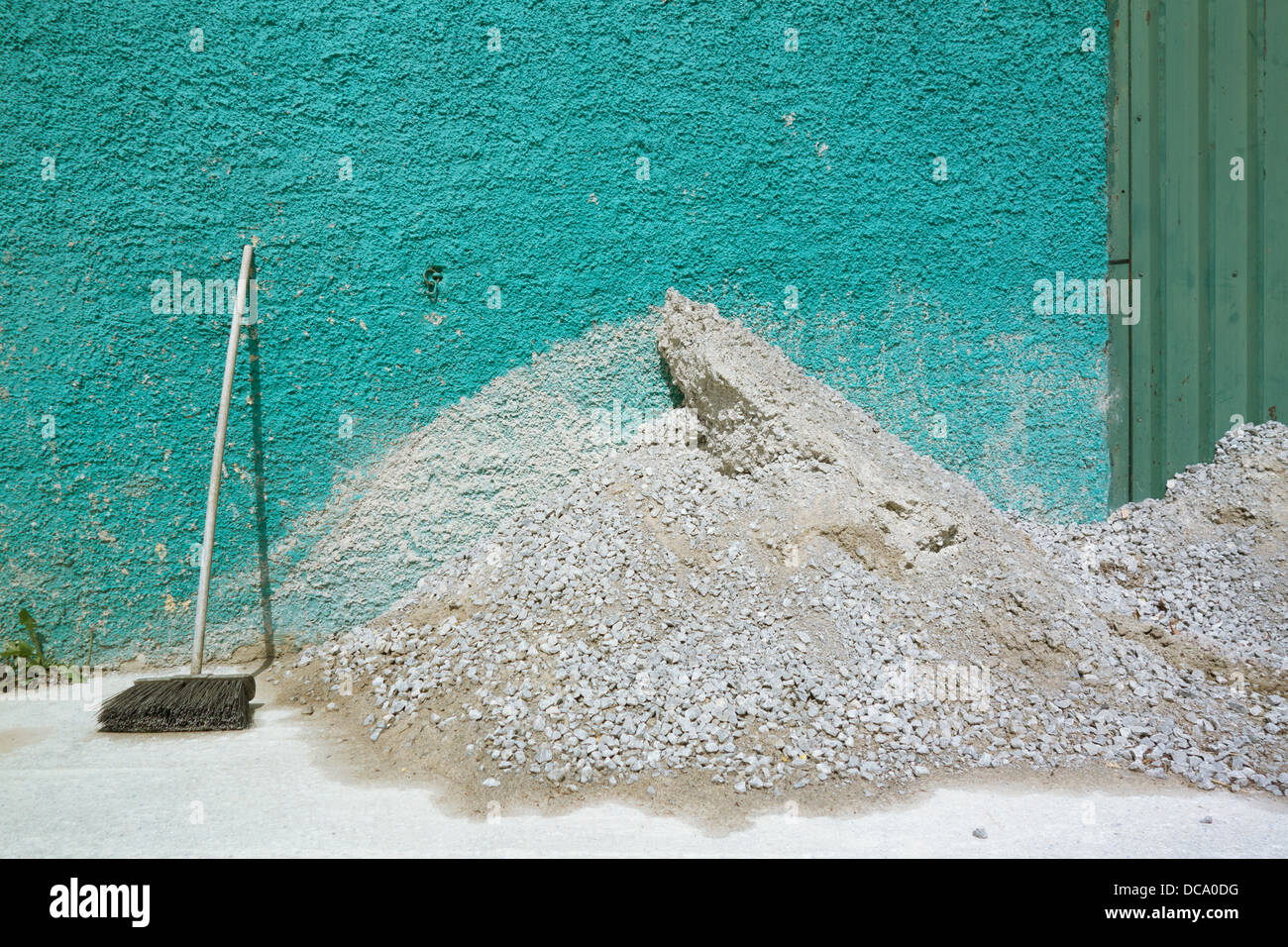 A mound of rubble piled up against an attractively coloured barn wall ...