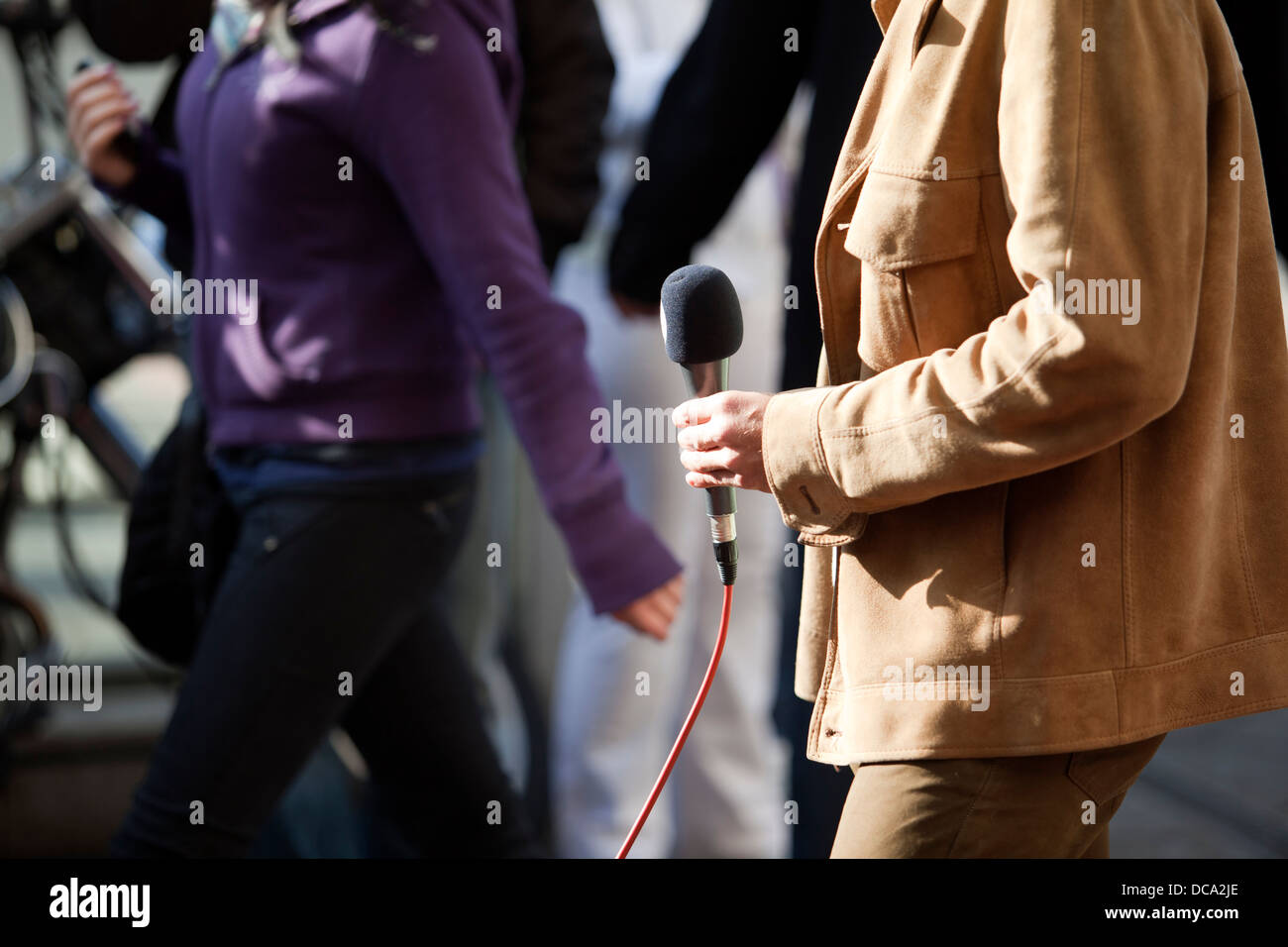 A journalist is making a interview with a microphone Stock Photo - Alamy