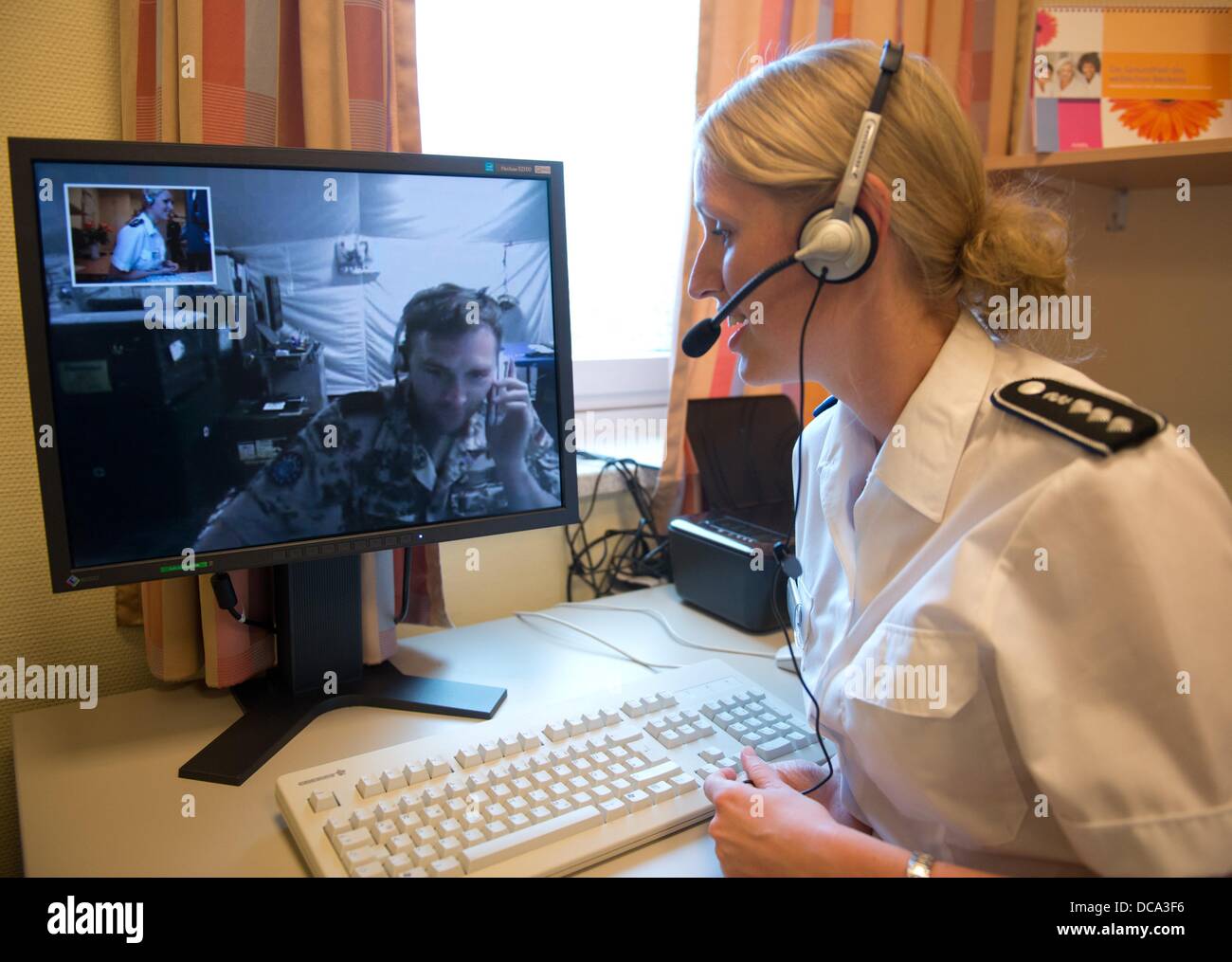 Staff army doctor Friederike Wehming talks to a German soldier serving ...