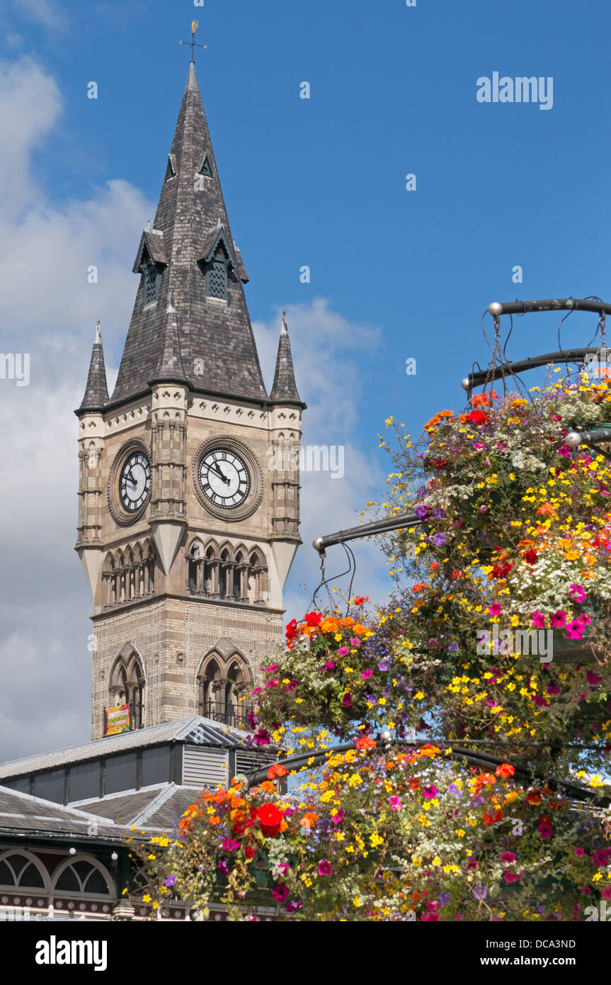 Darlington clock tower with floral display in hanging baskets in ...