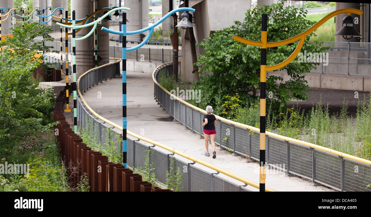 A female Jogger, running along a path, near the Charlestown bridge ...