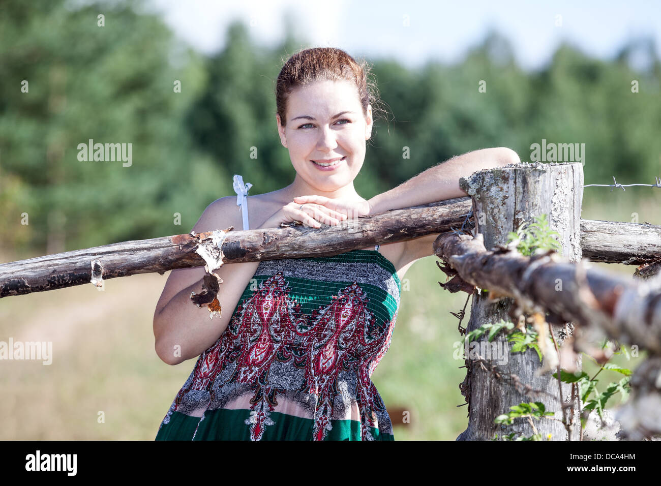 Portrait of pretty village girl in sundress looking at camera. Russian ...