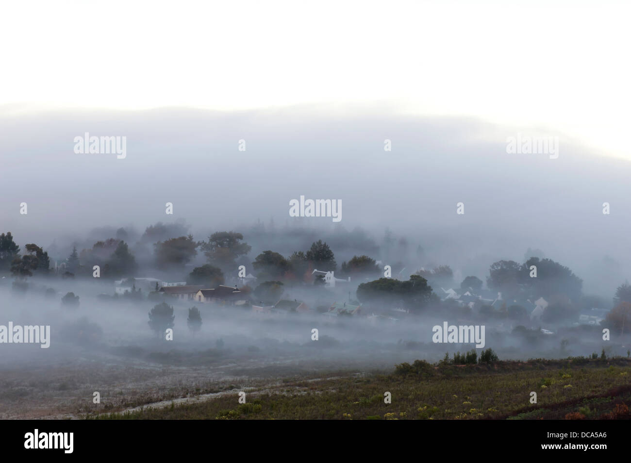 Town covered in fog Stock Photo - Alamy