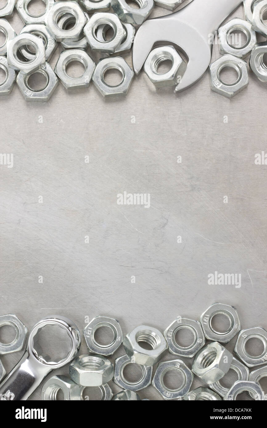 wrench and nut tool on metal background texture Stock Photo - Alamy