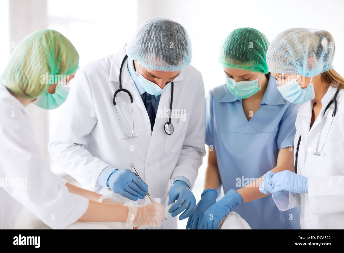 young group of doctors doing operation Stock Photo - Alamy