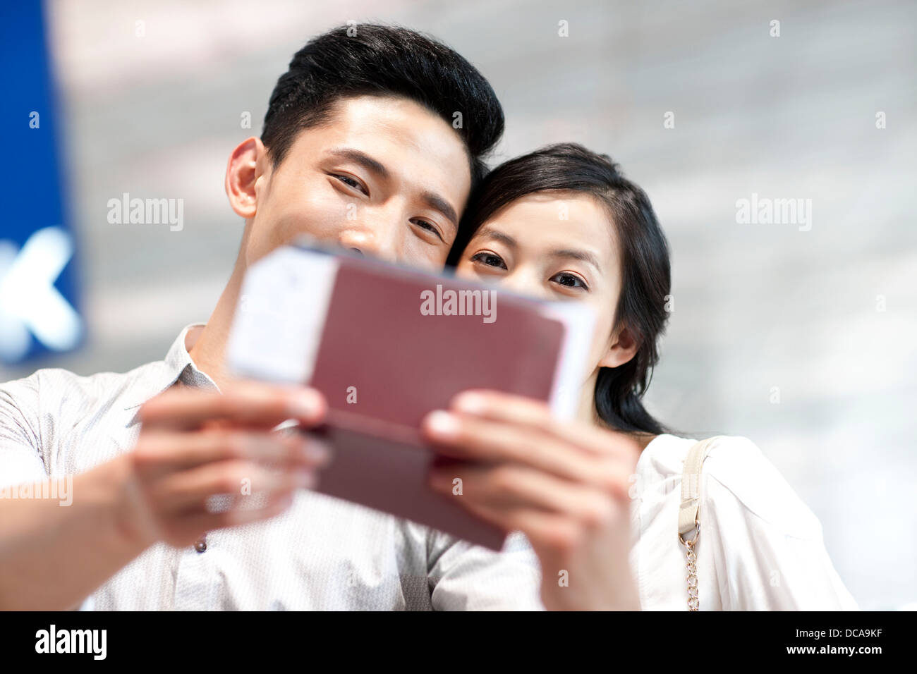 Young couple at the airport with flight tickets and passports Stock ...
