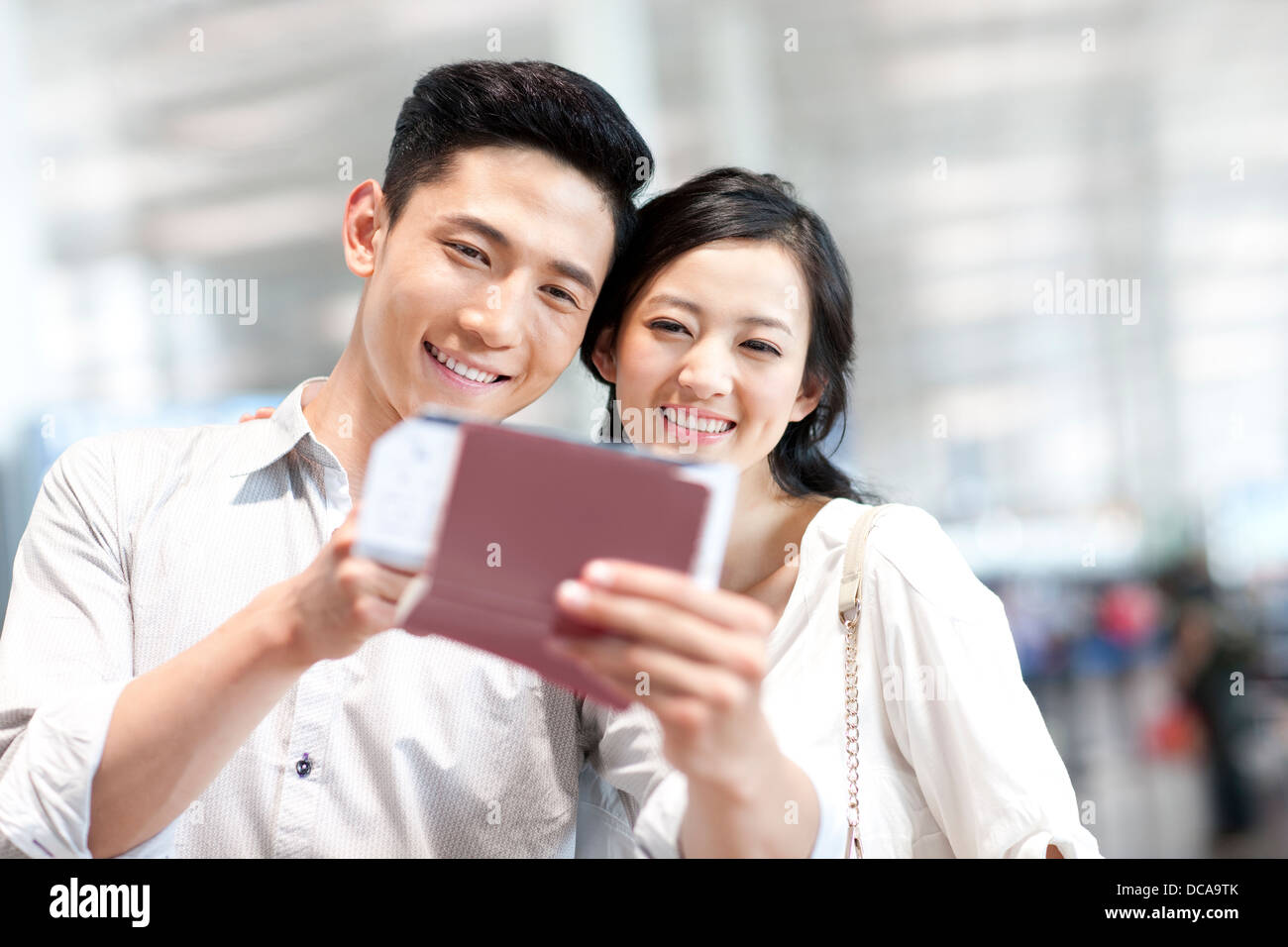 Young couple at the airport with flight tickets and passports Stock ...