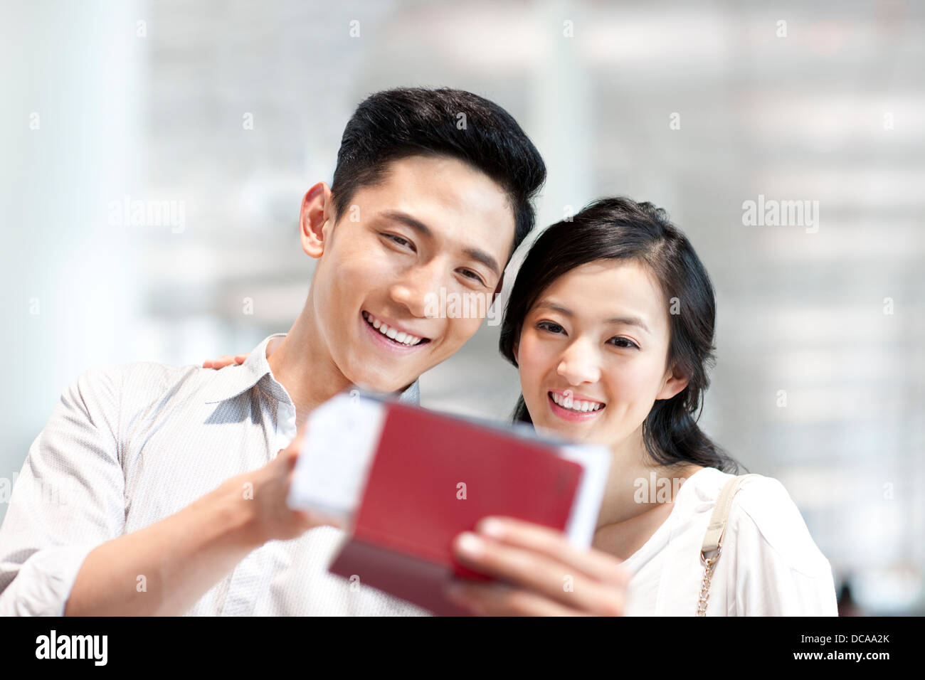 Young couple at the airport with flight tickets and passports Stock ...