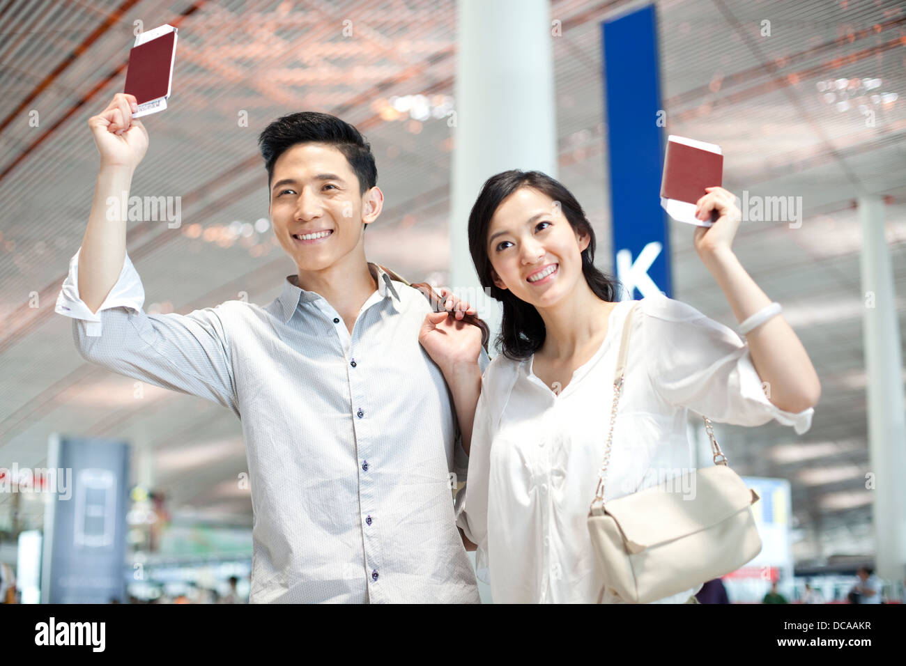 Young couple at the airport with flight tickets and passports Stock ...