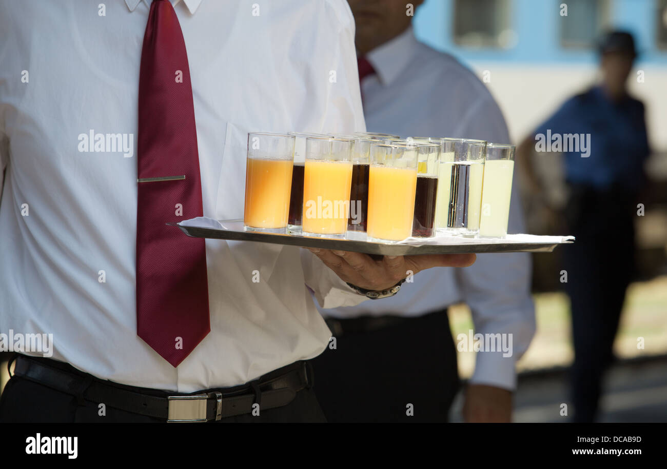 waiter serving soft drinks at a party Stock Photo - Alamy