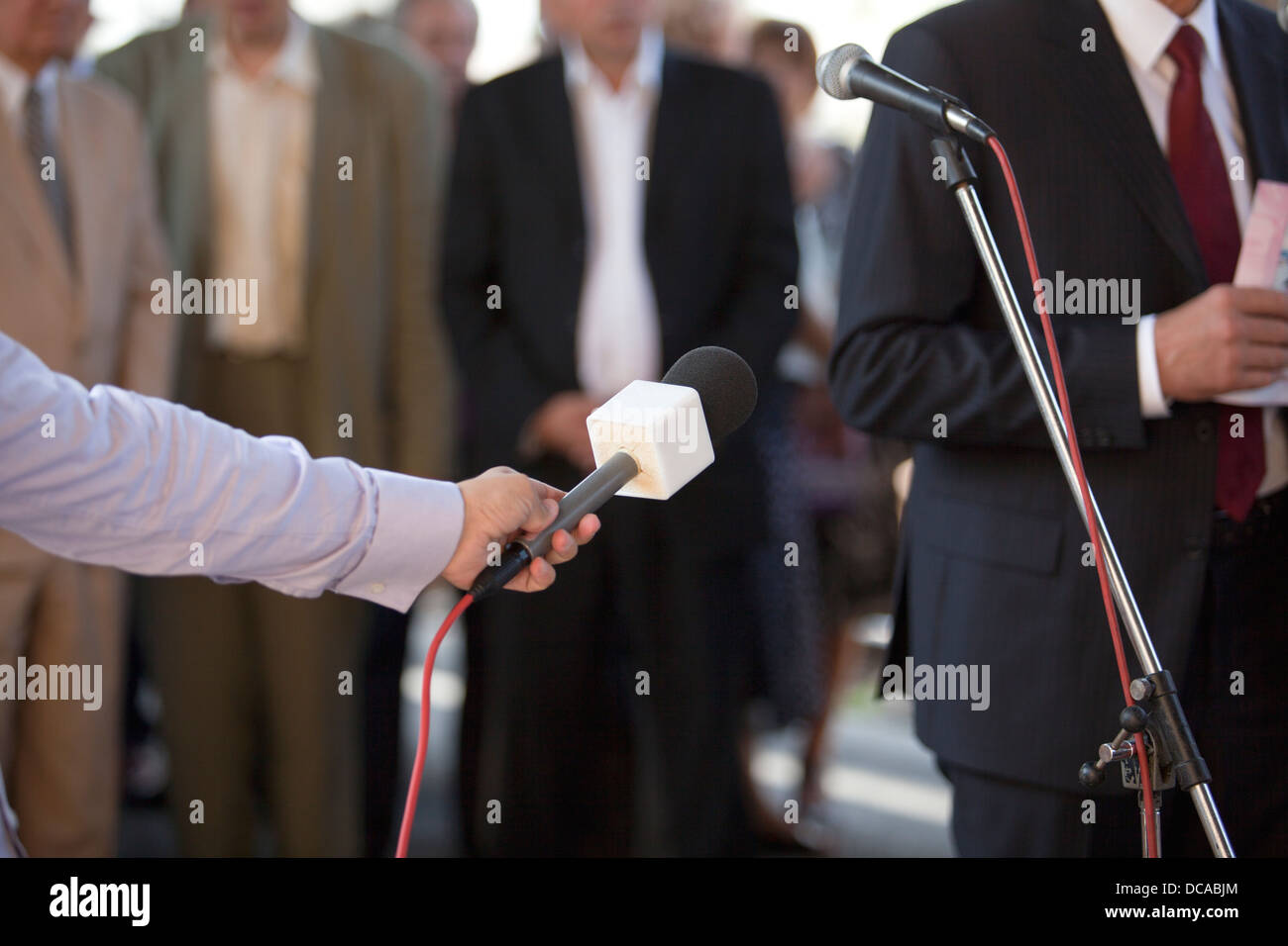 journalist hand holding a microphone conducting an TV or radio ...