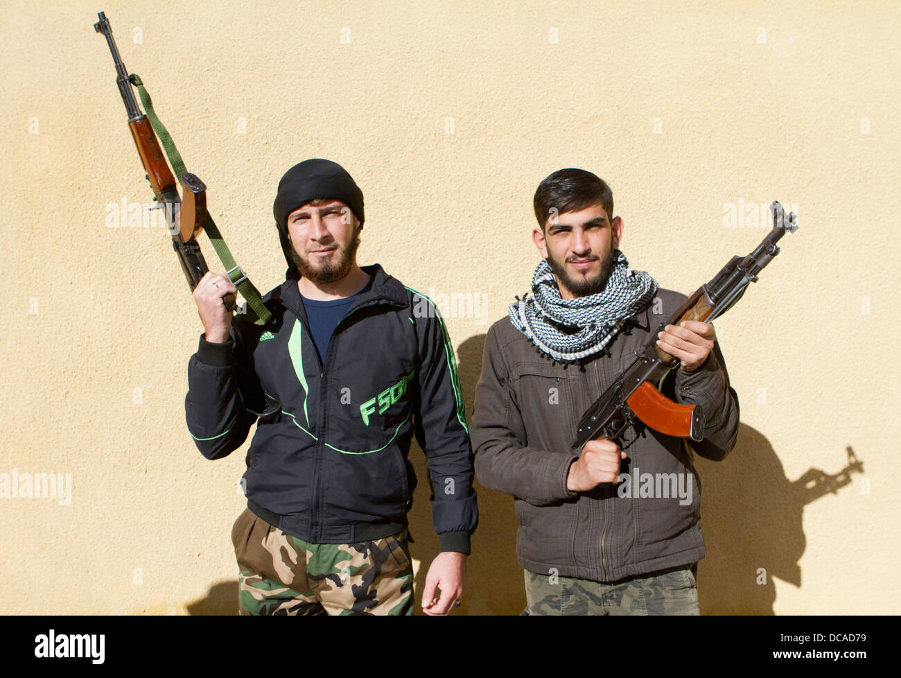 Free Syrian Army rebels stand with their weapons Stock Photo - Alamy