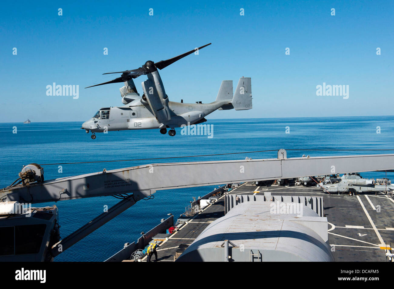 An MV-22 Osprey launches from the flight deck of amphibious transport ...