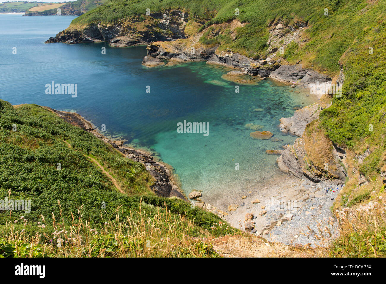 Secluded beach and cove with turquoise sea Black Head headland St ...