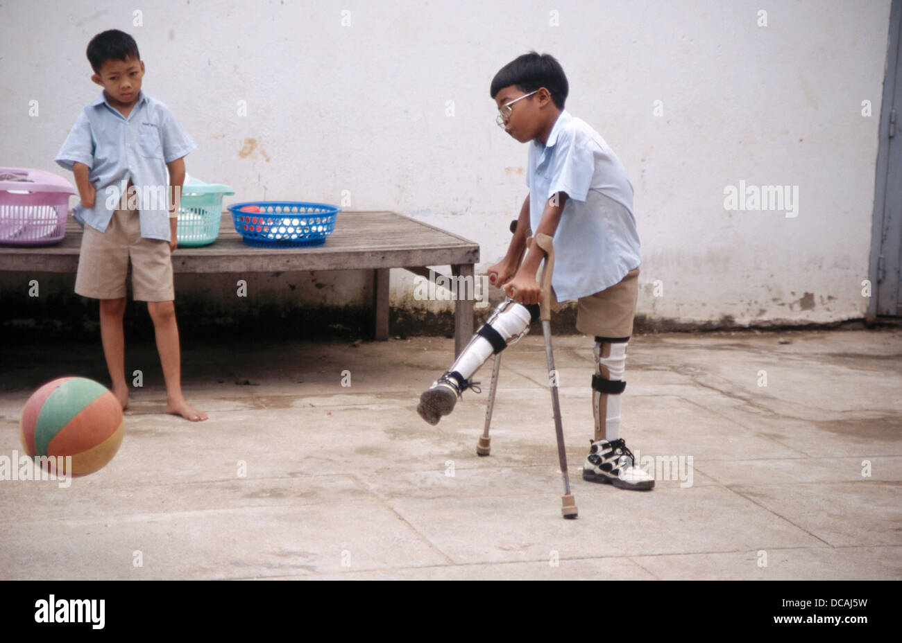 Disabled boy playing soccer. Phnom Penh. Cambodia Stock Photo - Alamy