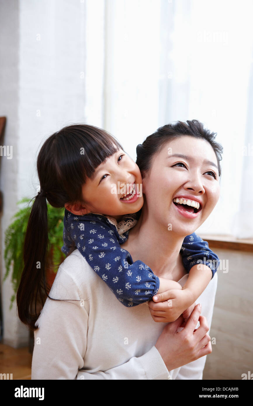 daughter hugging mother from behind Stock Photo - Alamy