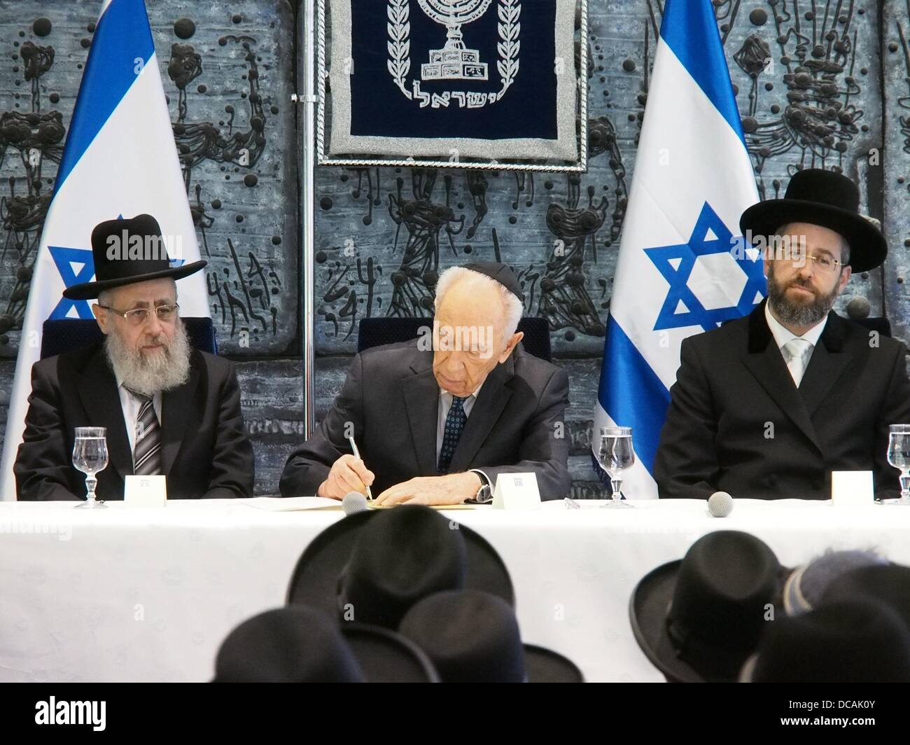Jerusalem, Israel. 14th Aug, 2013. President SHIMON PERES (C) signs the ...