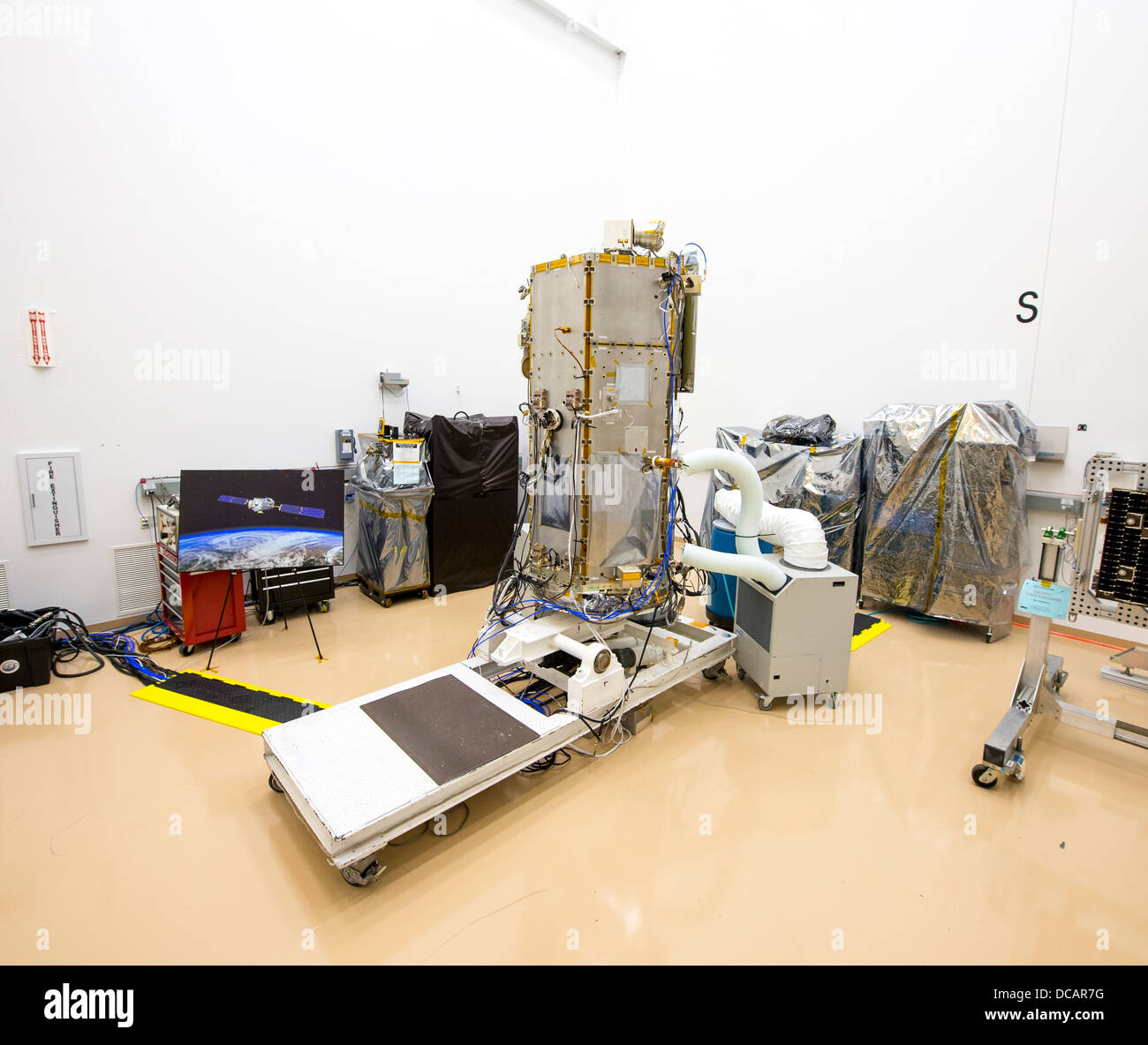 The NASA Administrator inspects the OCO-2 satellite in a clean room ...