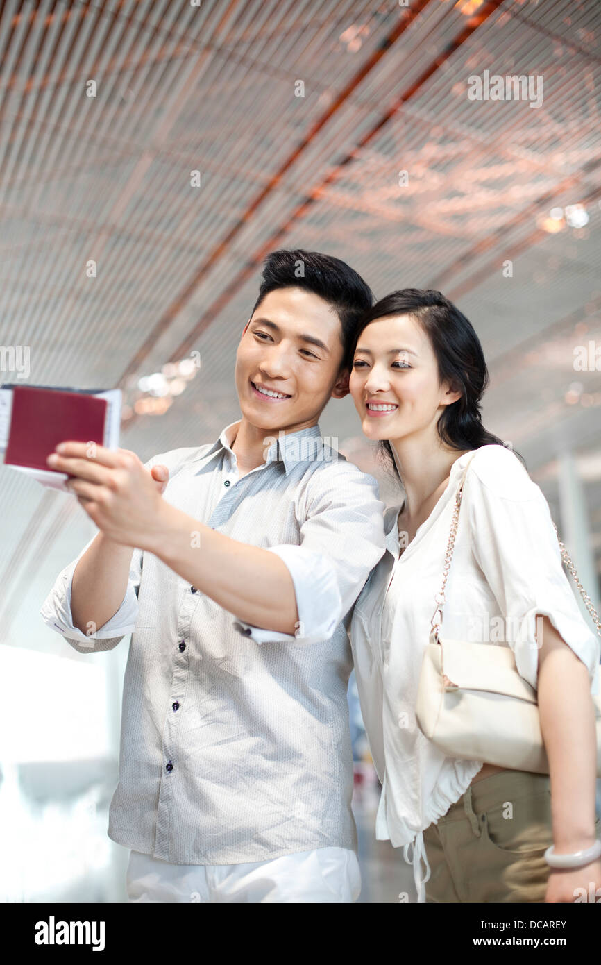 Young couple at the airport with flight tickets and passports Stock ...