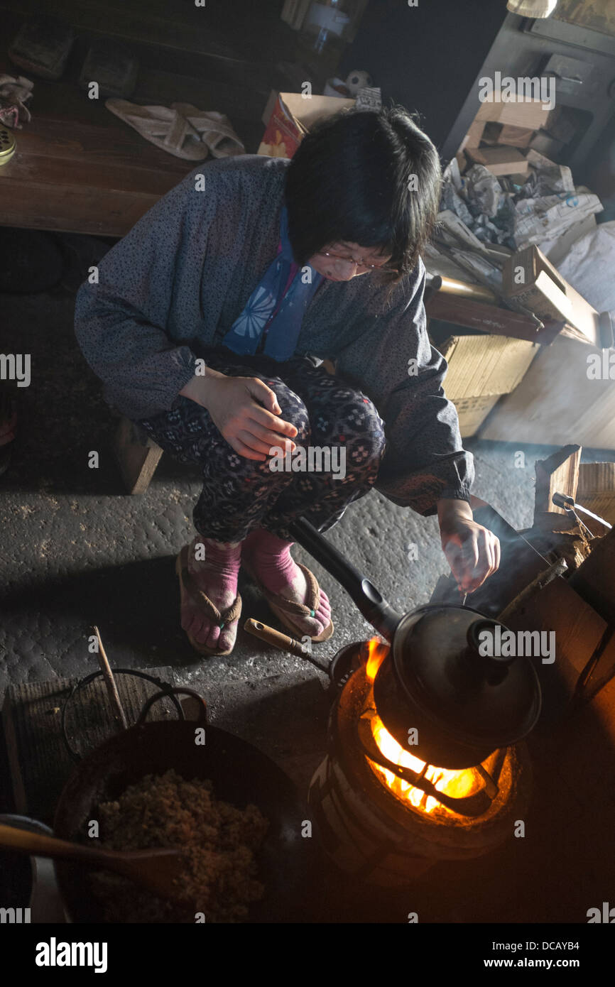 Cooking on an open fire in a traditional Japanese wood-built house near ...