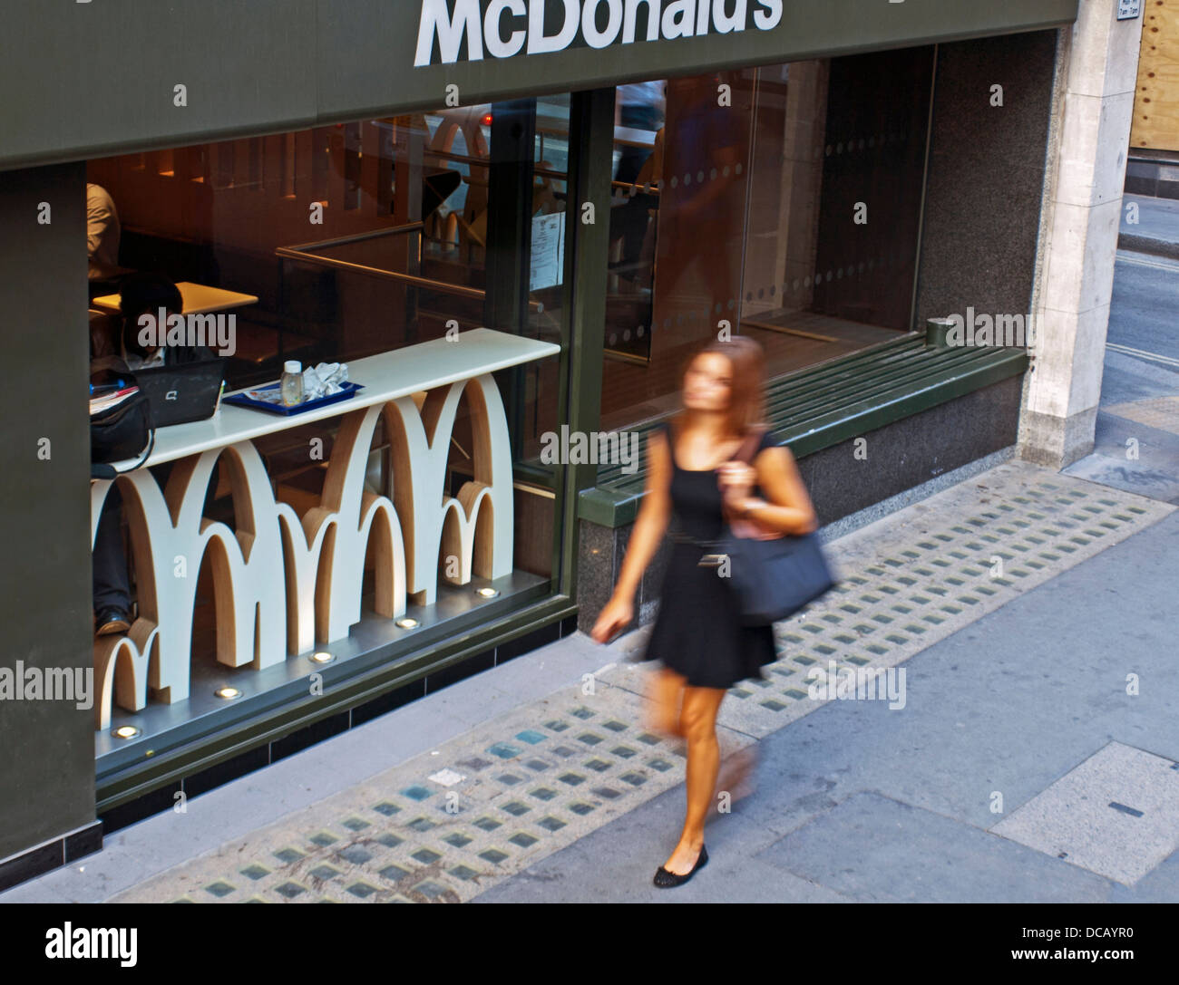 Young lady walking in front of Mcdonald's fast food restaurant, Strand ...
