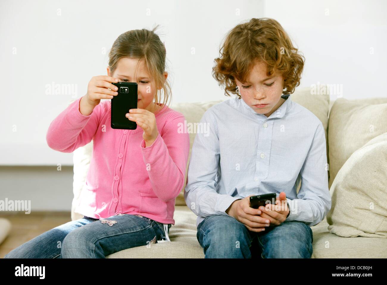 Children using smartphones Stock Photo - Alamy