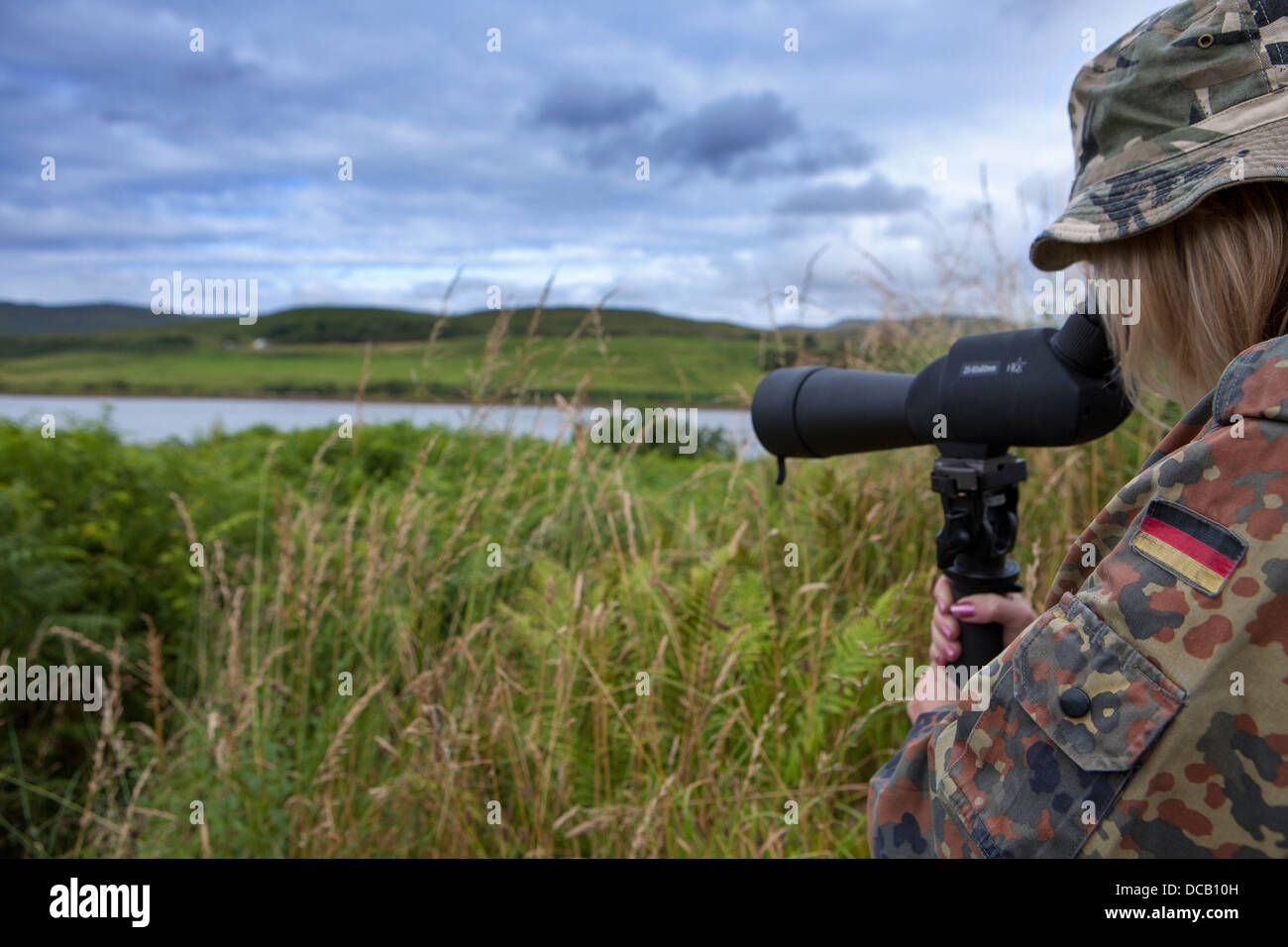 Bird sightings, observation watching wildlife. Female birdwatcher with ...