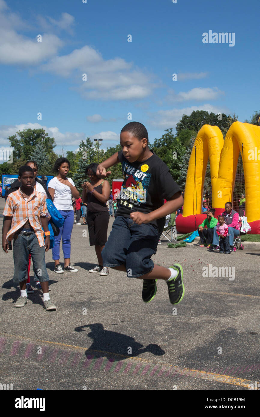 Detroit, Michigan USA. A boy jumps rope at a Back to School Festival ...