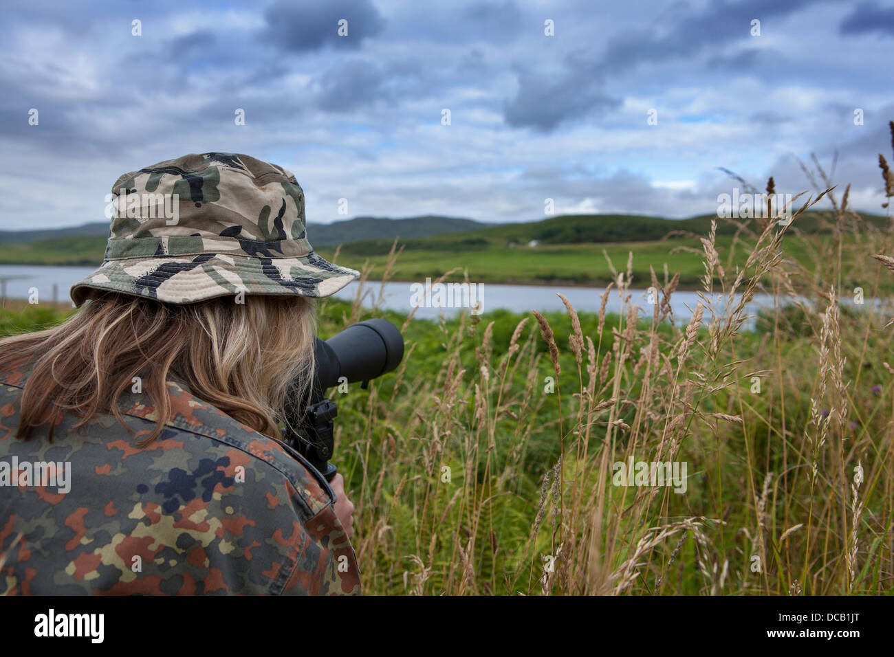 Bird sightings, observation watching wildlife. Female birdwatcher with ...