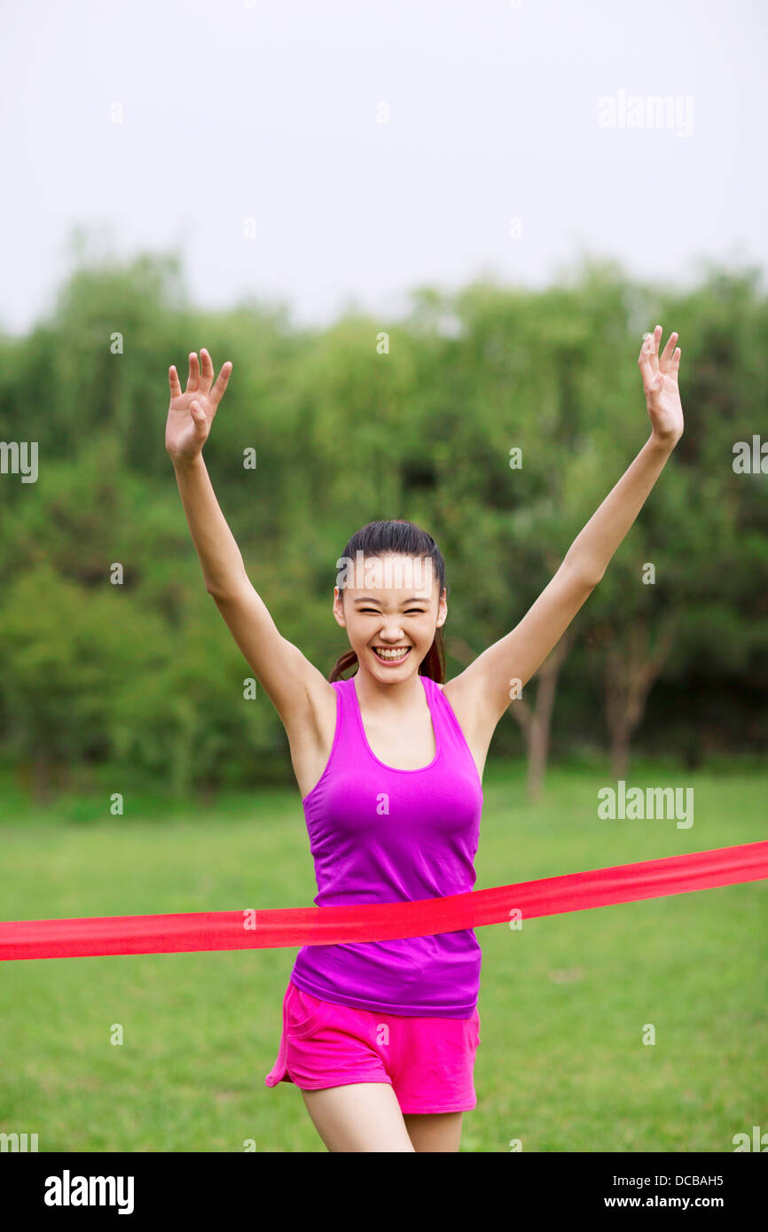 Young women to cross the finish line Stock Photo - Alamy