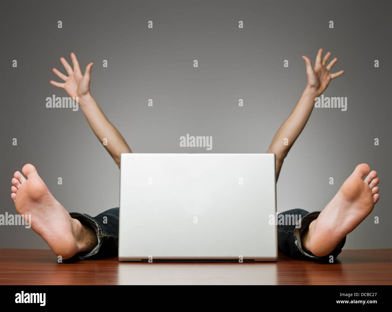 Happy man behind computer Stock Photo - Alamy