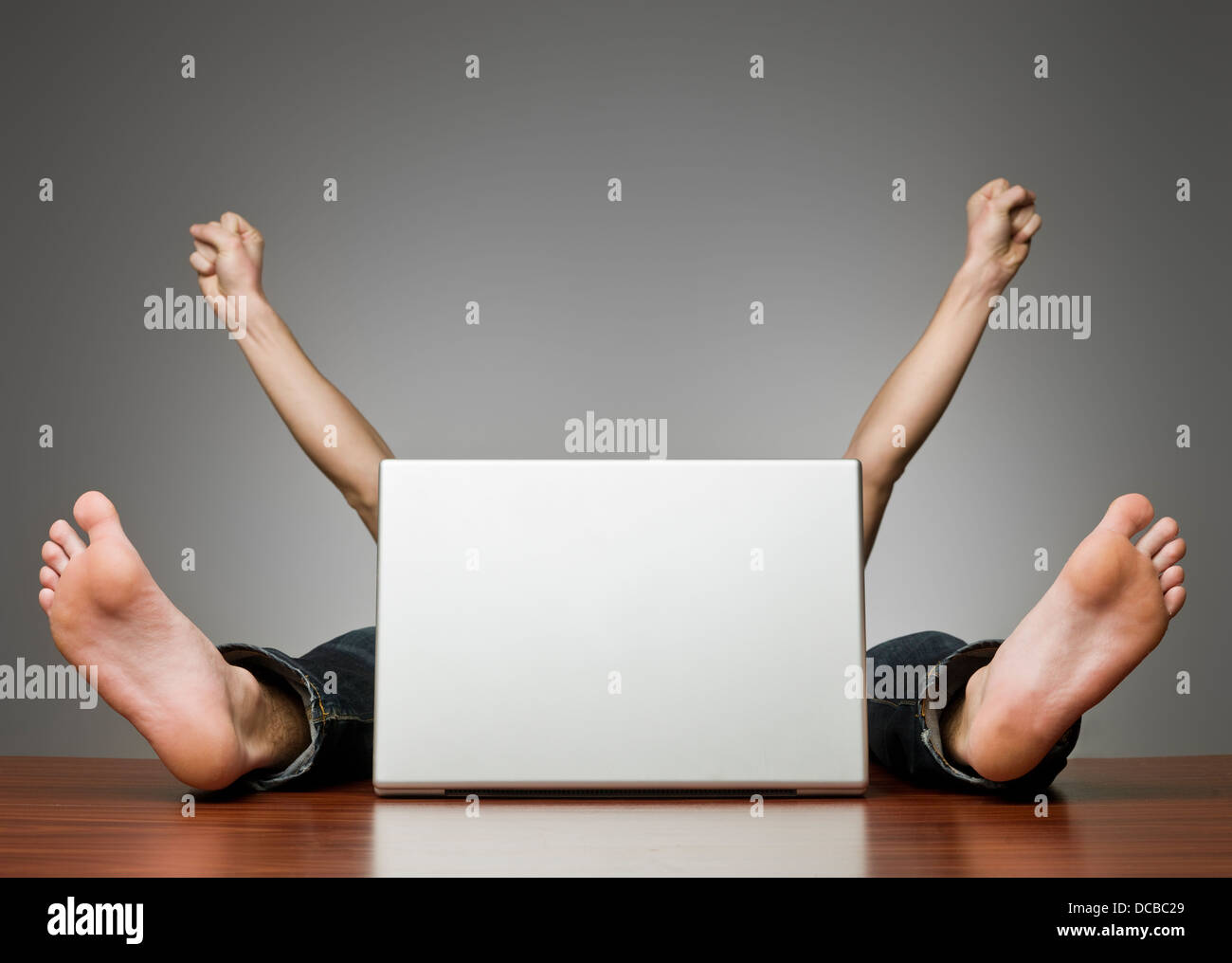 Happy man behind computer Stock Photo - Alamy