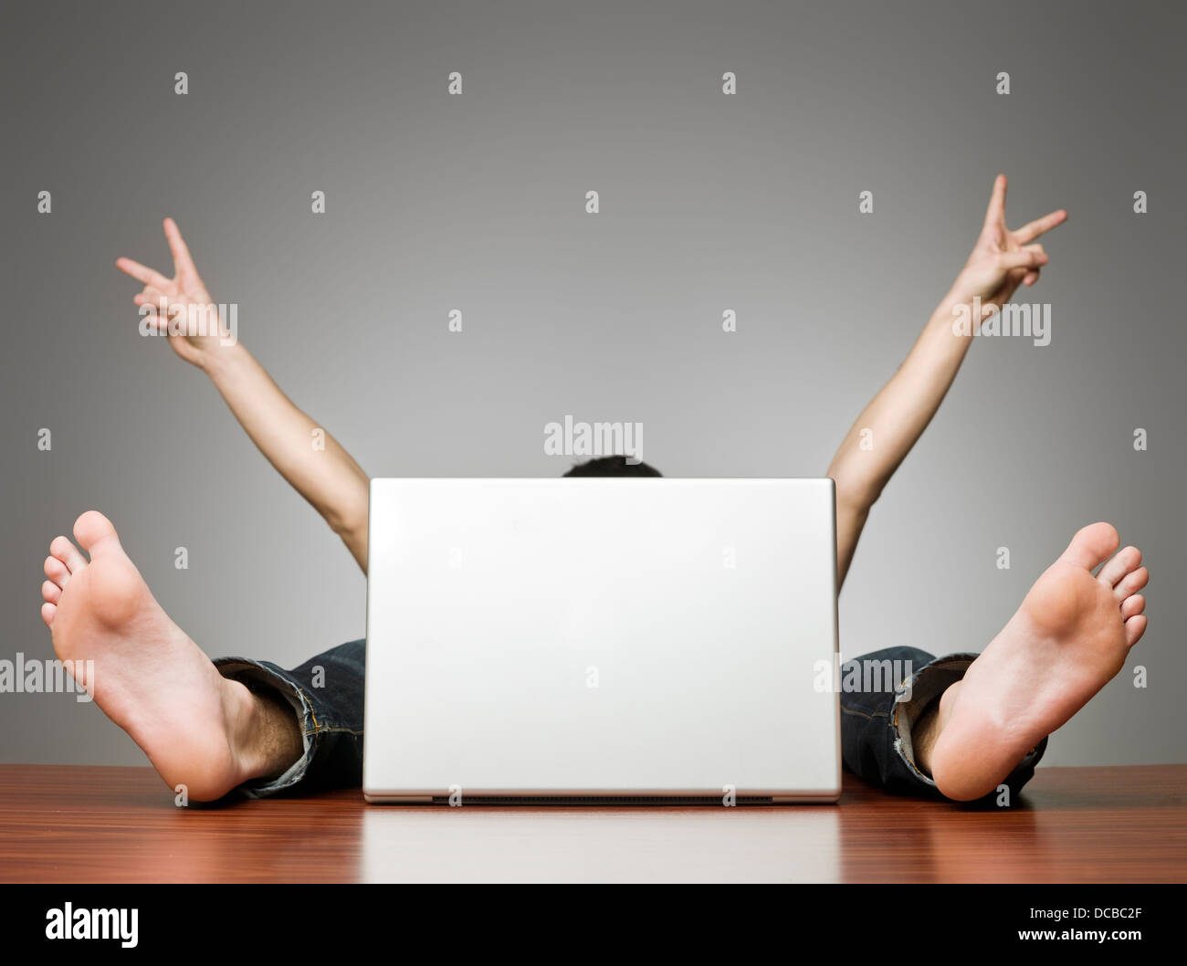 Happy man behind computer Stock Photo - Alamy