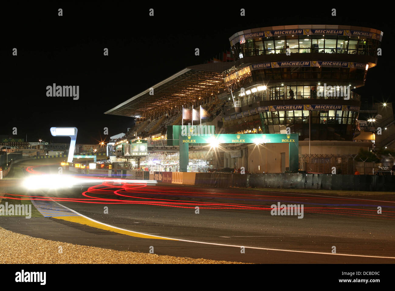 Night racing scene shows the pit straight at the 2013 Le Mans 24 Hours ...