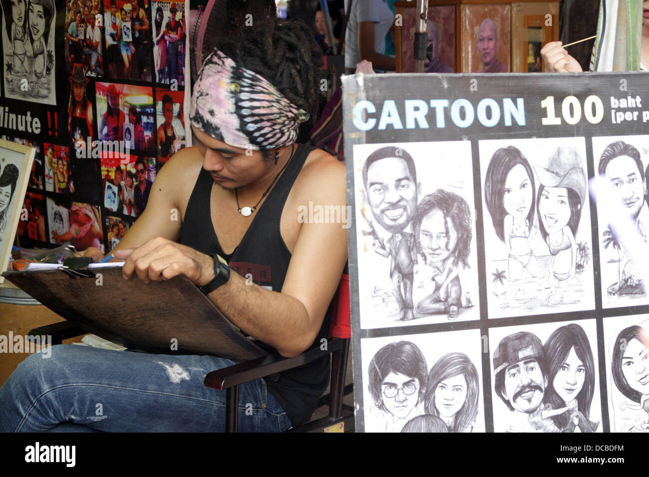 Artist drawing portrait for customer in shop at Chatuchak Weekend ...