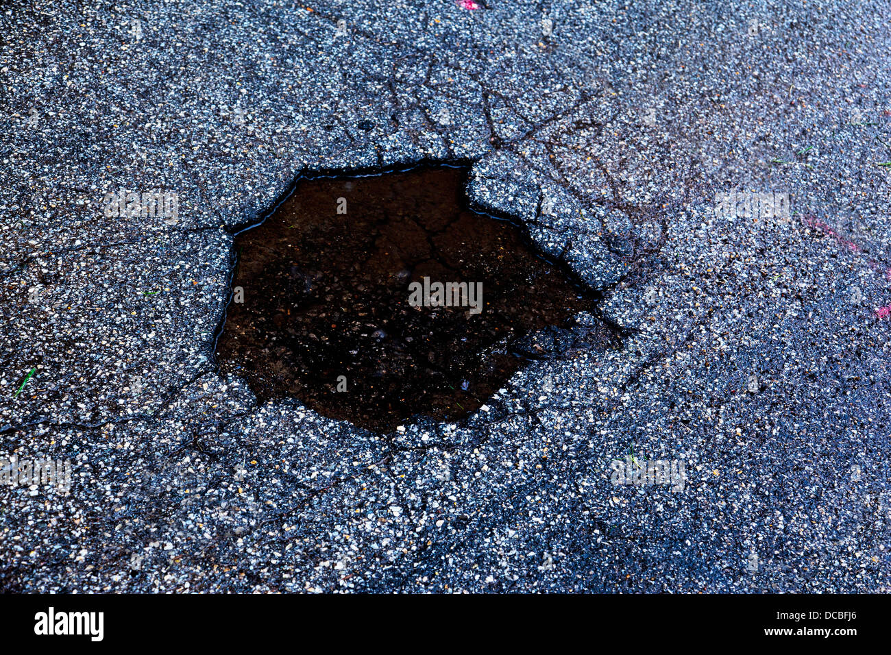 Pothole in road,filled with water Stock Photo - Alamy