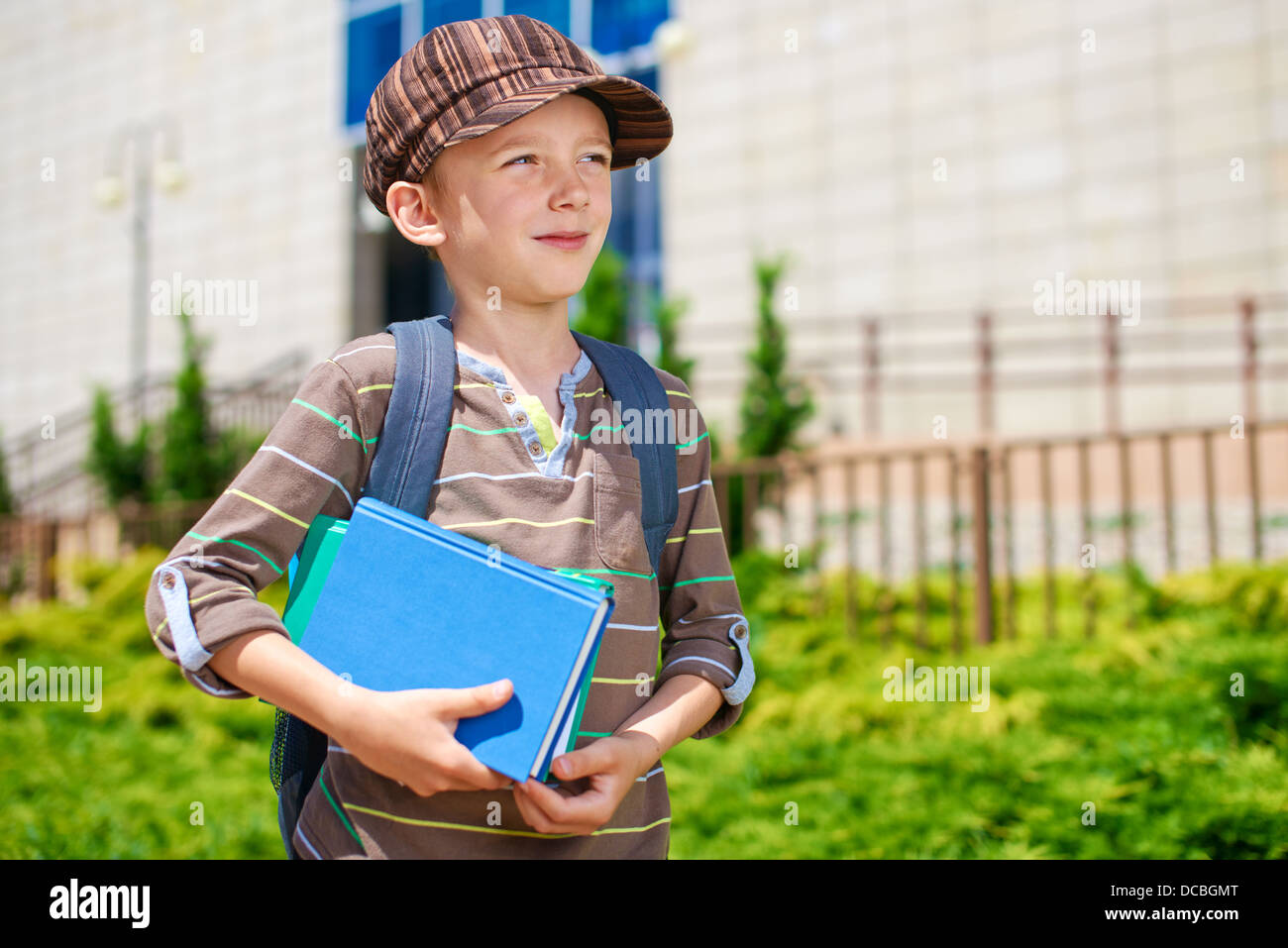Young pensive kid in front of school building Stock Photo - Alamy