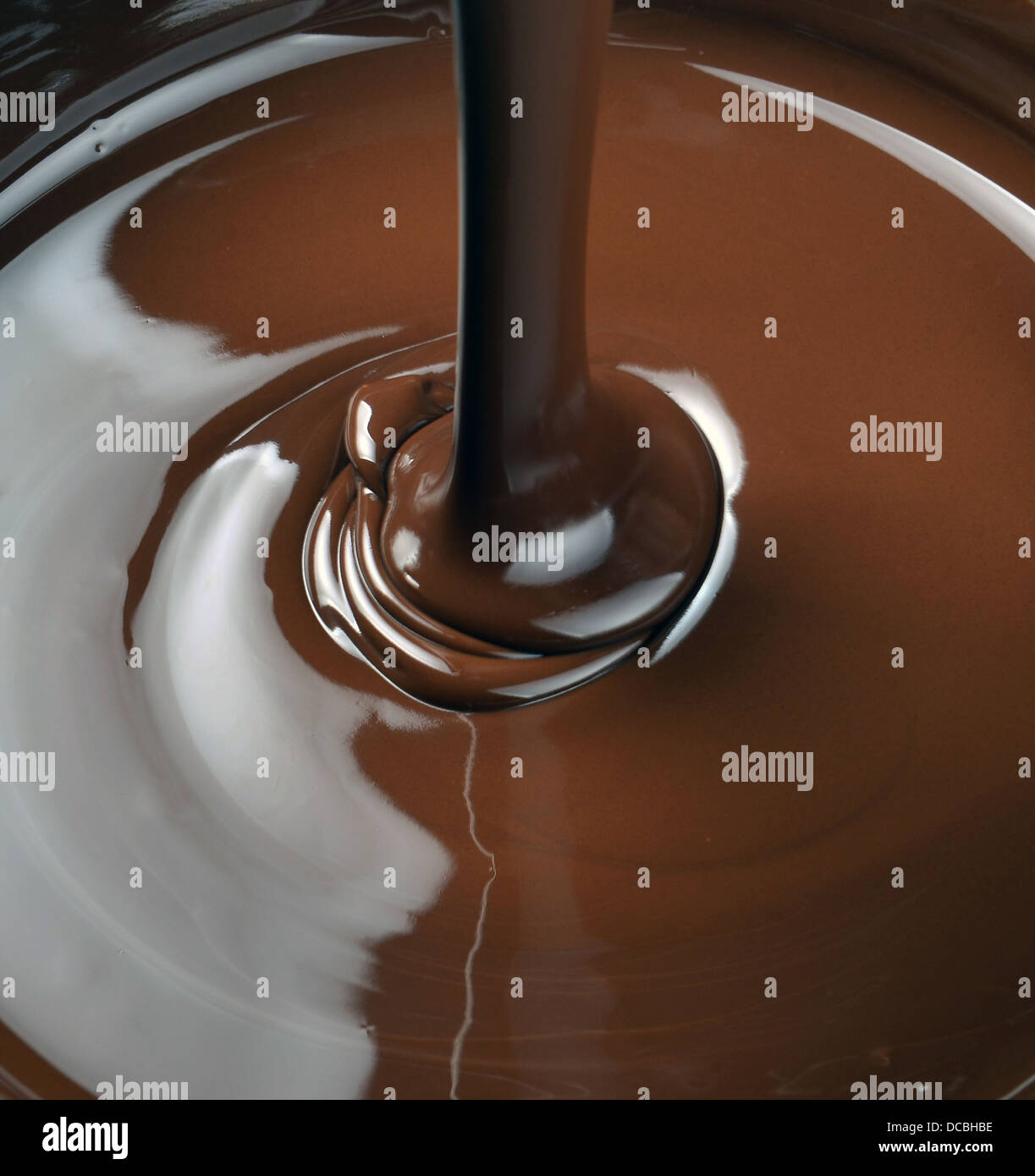 Melted chocolate pouring from cooking hi-res stock photography and ...