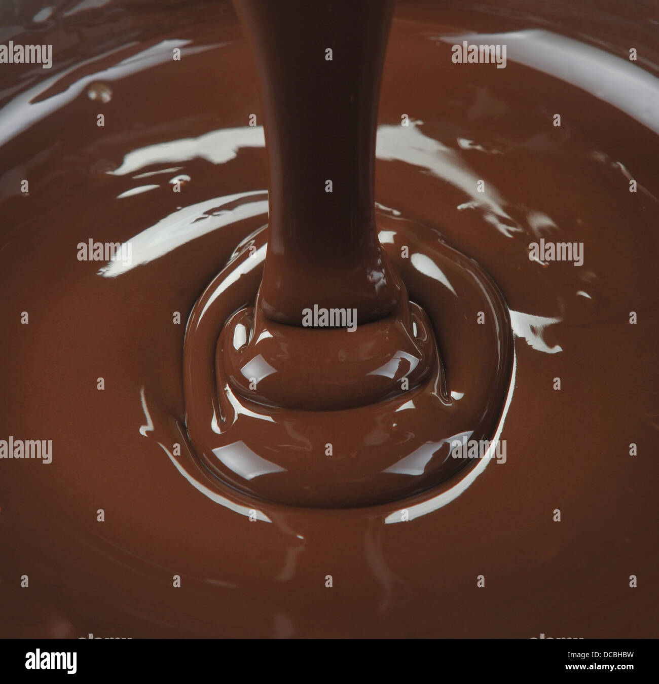Melted chocolate pouring from cooking hi-res stock photography and ...