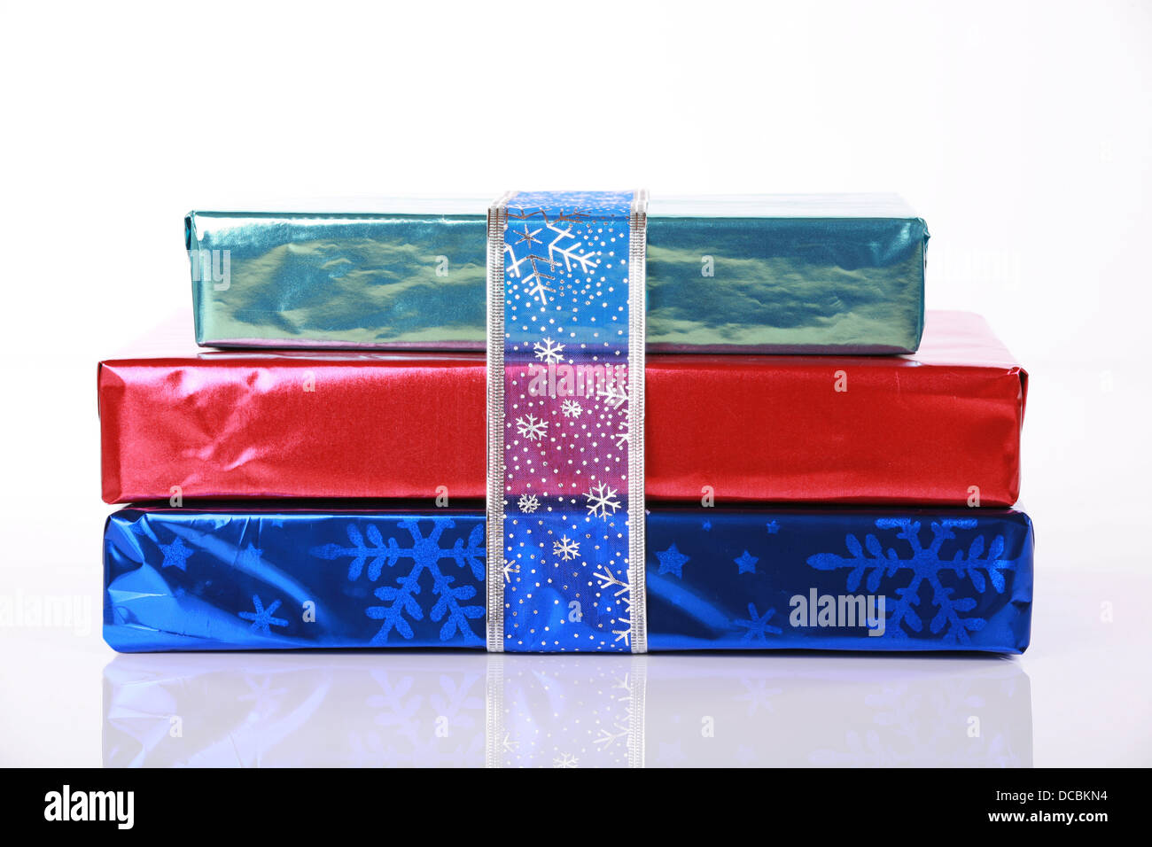 Three shiny colorful Christmas presents Stock Photo - Alamy