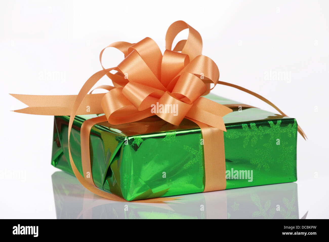 Green present with orange bow Stock Photo - Alamy
