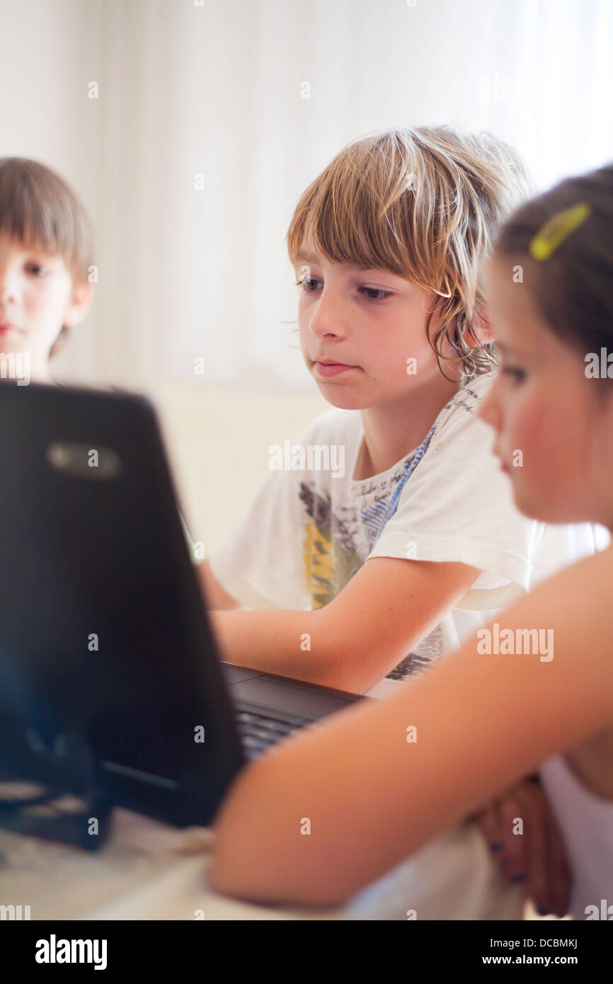 Children watching laptop Stock Photo - Alamy