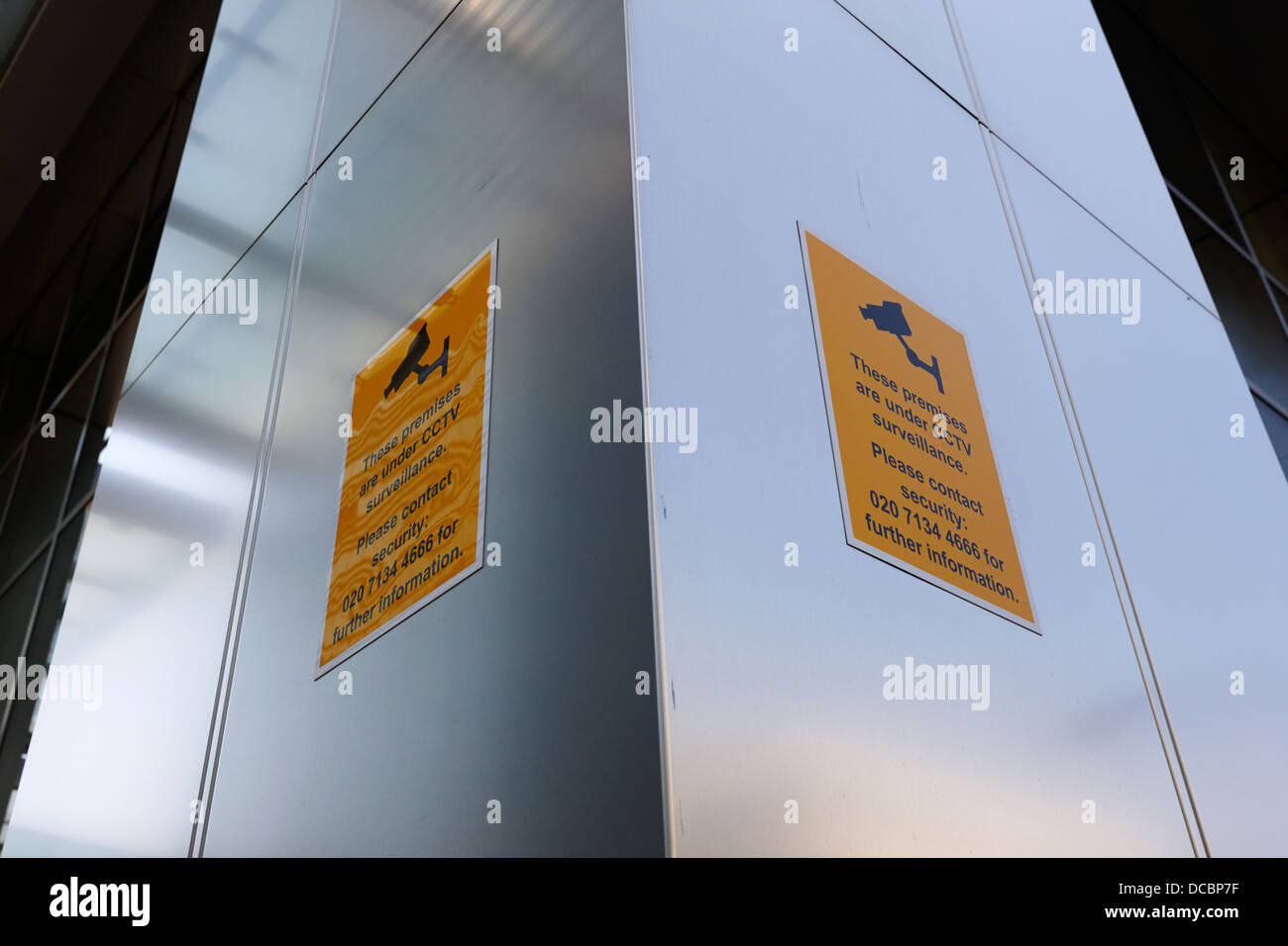 premises under cctv surveillance signs in canary wharf London England ...