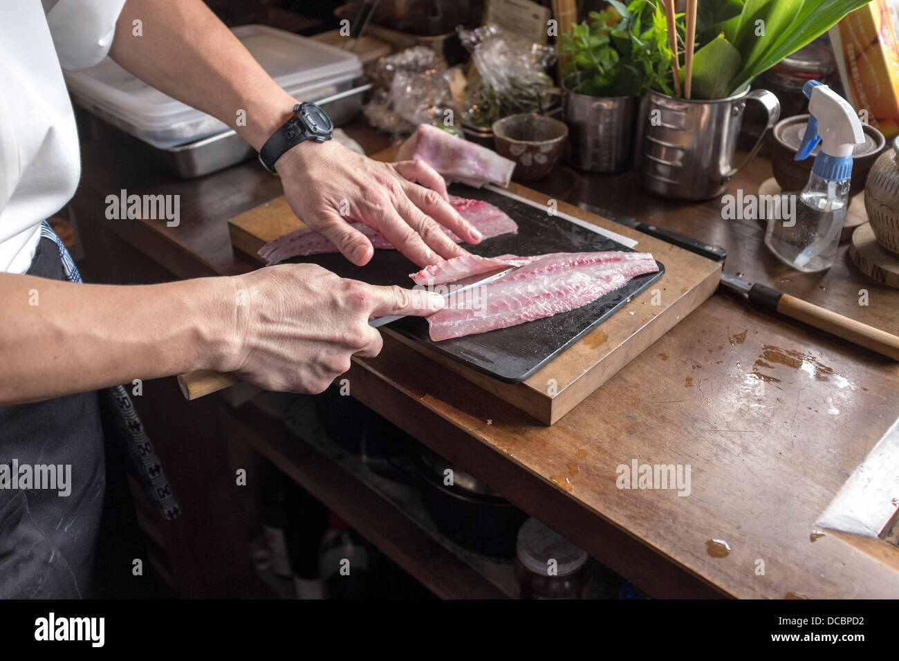 Japanese chef preparing traditional Japanese food in a traditional ...